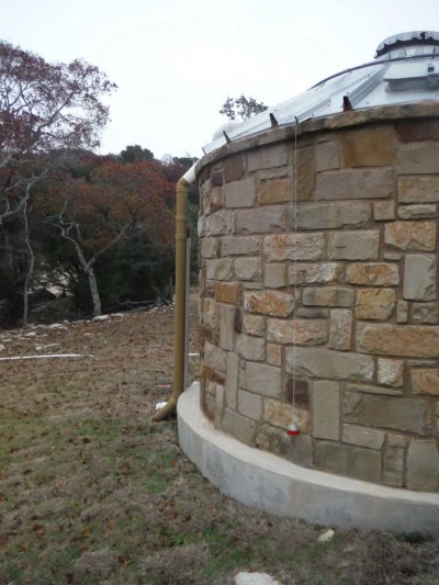 Masonry clad or wrapped cisterns for aesthetic installations